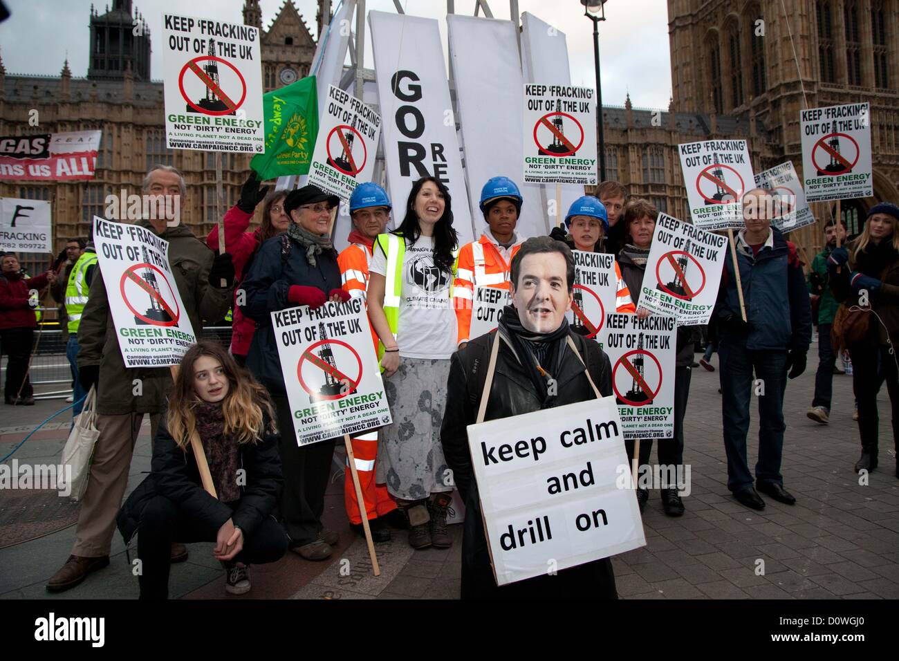 London, UK. 1st December 2012 The protestors stand in front of a mock ...