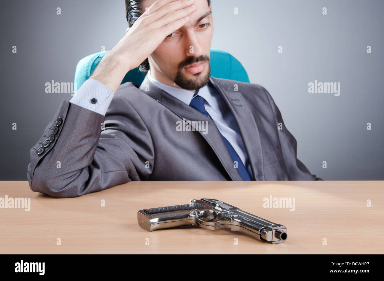 Businessman man with hand gun Stock Photo - Alamy