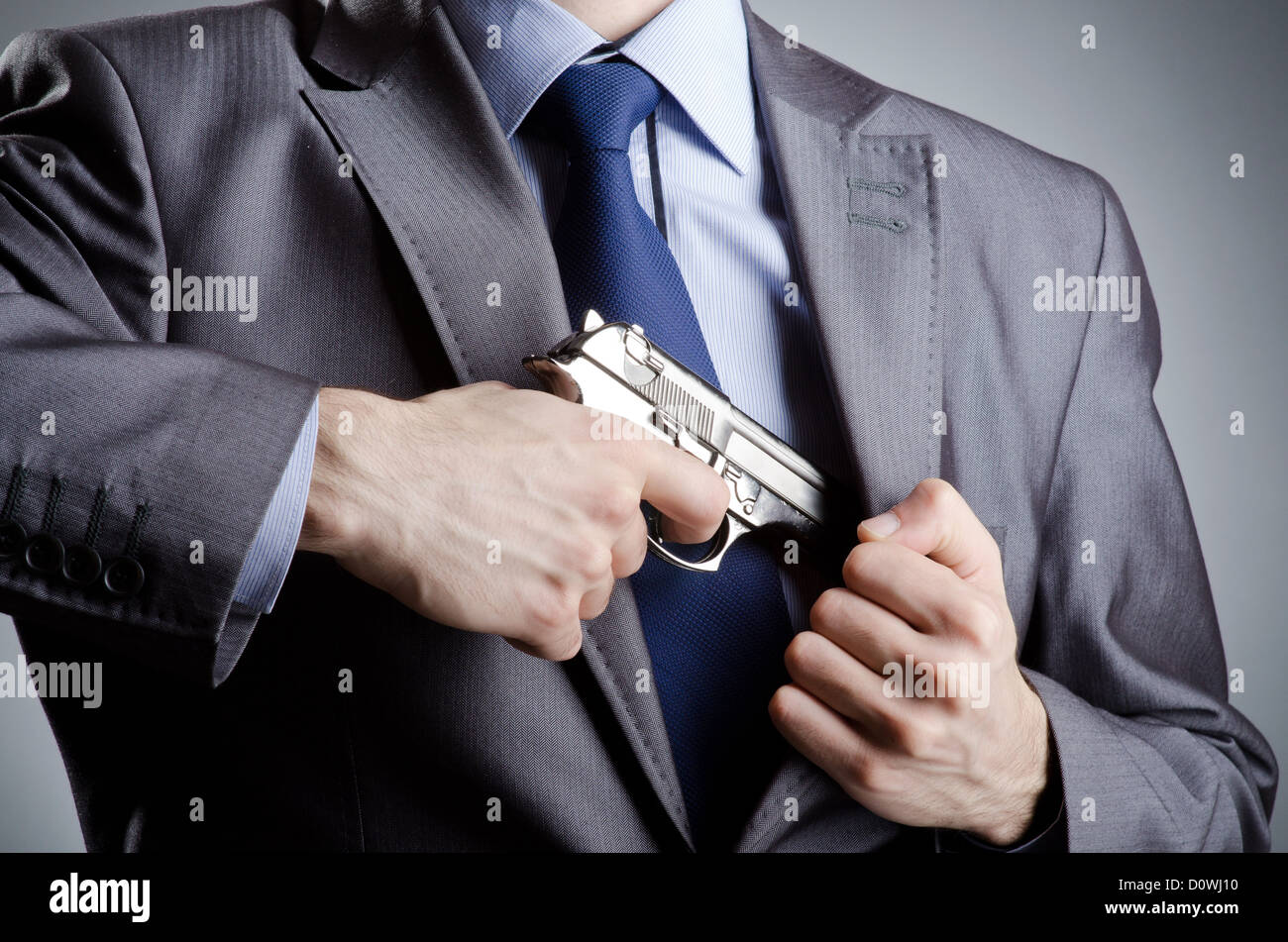 Businessman man with hand gun Stock Photo - Alamy