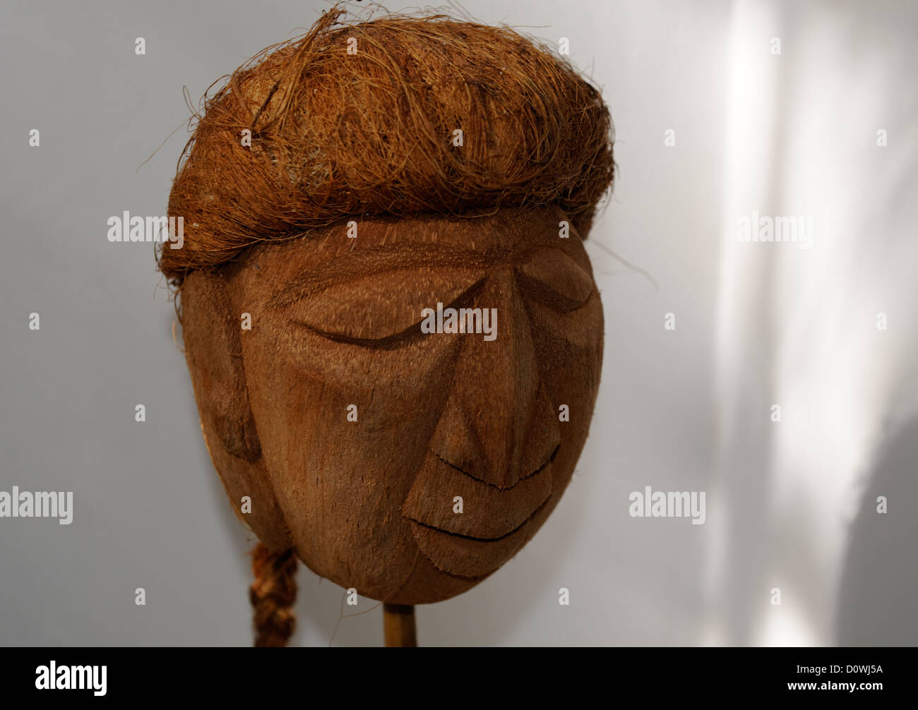Coconut carved as human faces on sticks as household decoration Stock ...
