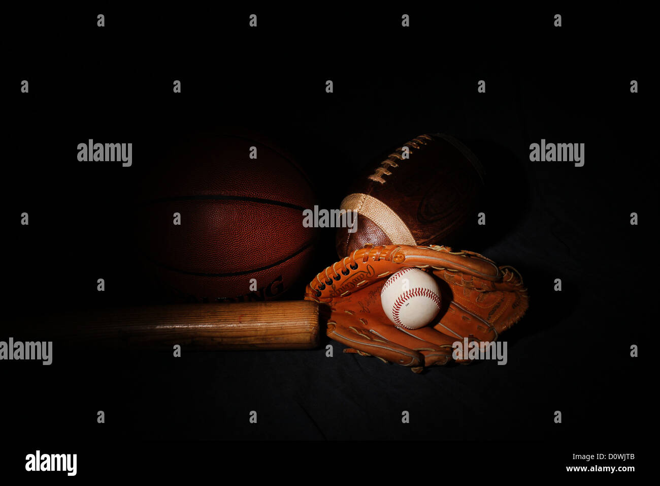 A studio shot of an American Football, a basketball and a baseball ball ...
