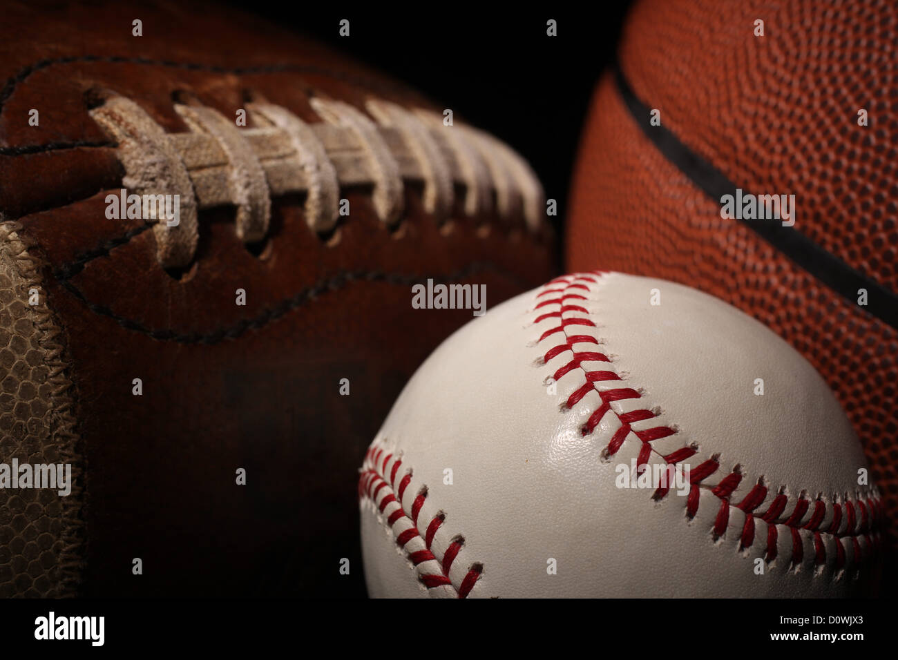 A studio shot of an American Football, a baseball, and a basketball ...