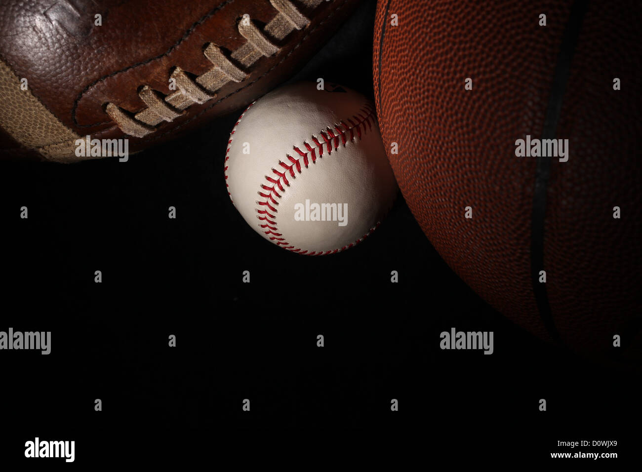 A studio shot of an American Football, a baseball, and a basketball ...