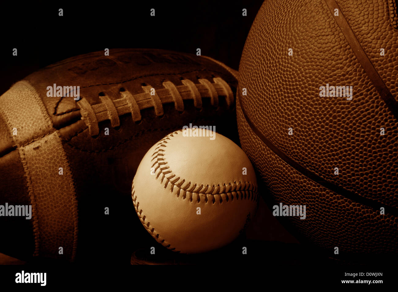 A studio shot of an American Football, a baseball, and a basketball ...
