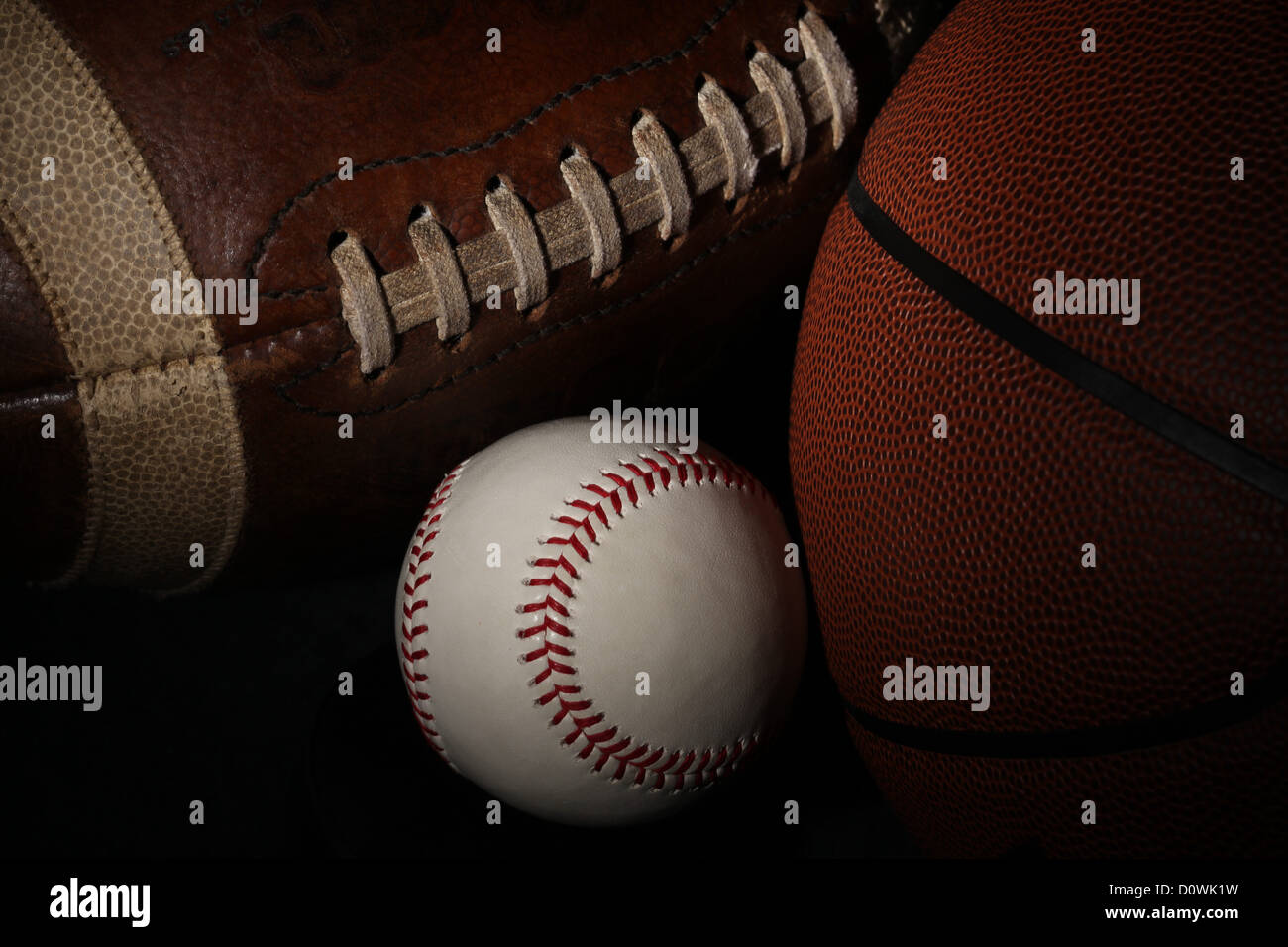 A studio shot of an American Football, a baseball, and a basketball ...