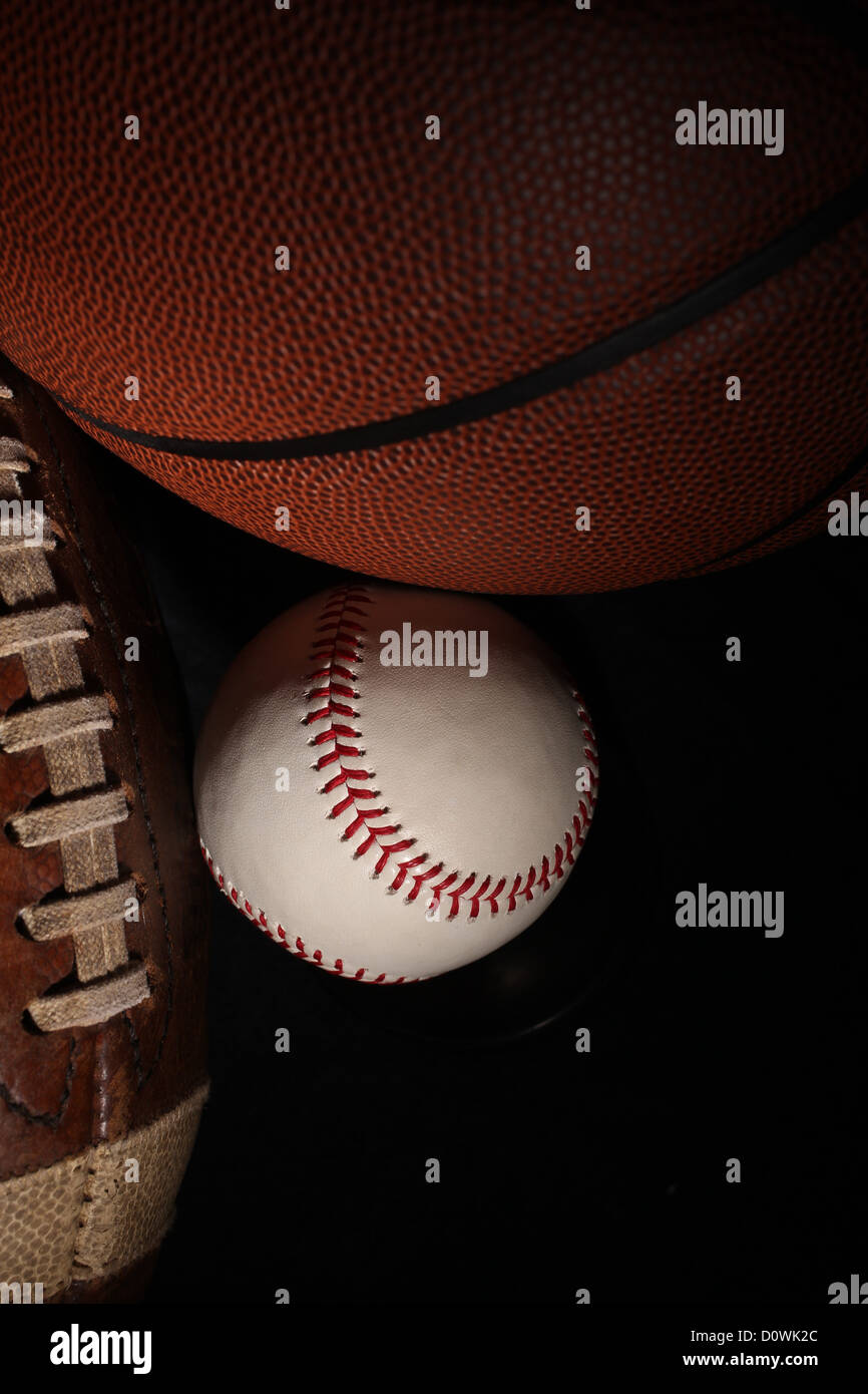 A studio shot of an American Football, a baseball, and a basketball ...