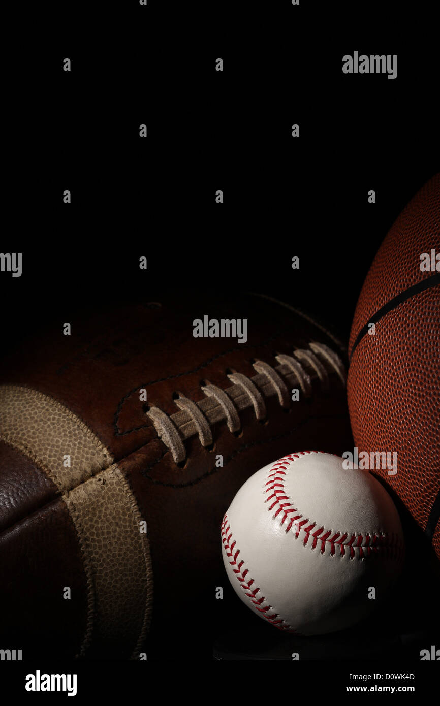 A studio shot of an American Football, a baseball, and a basketball ...