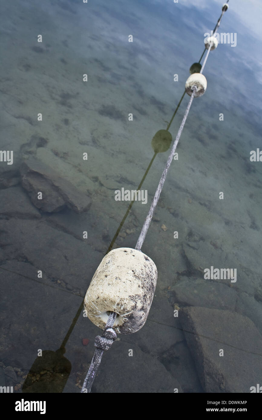 Water surface with floats on rope Stock Photo - Alamy