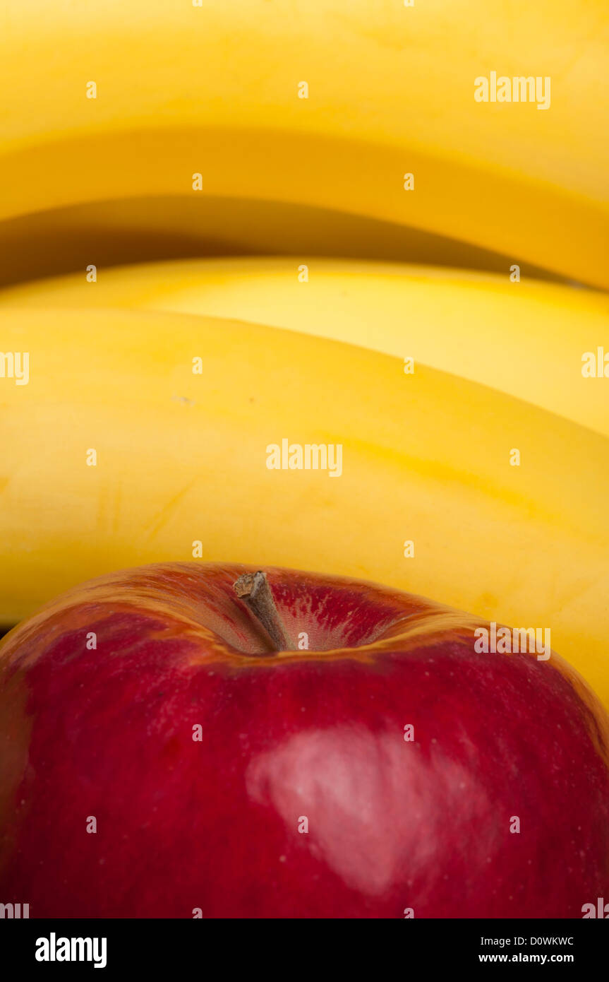 Red apple and bananas close up background Stock Photo - Alamy