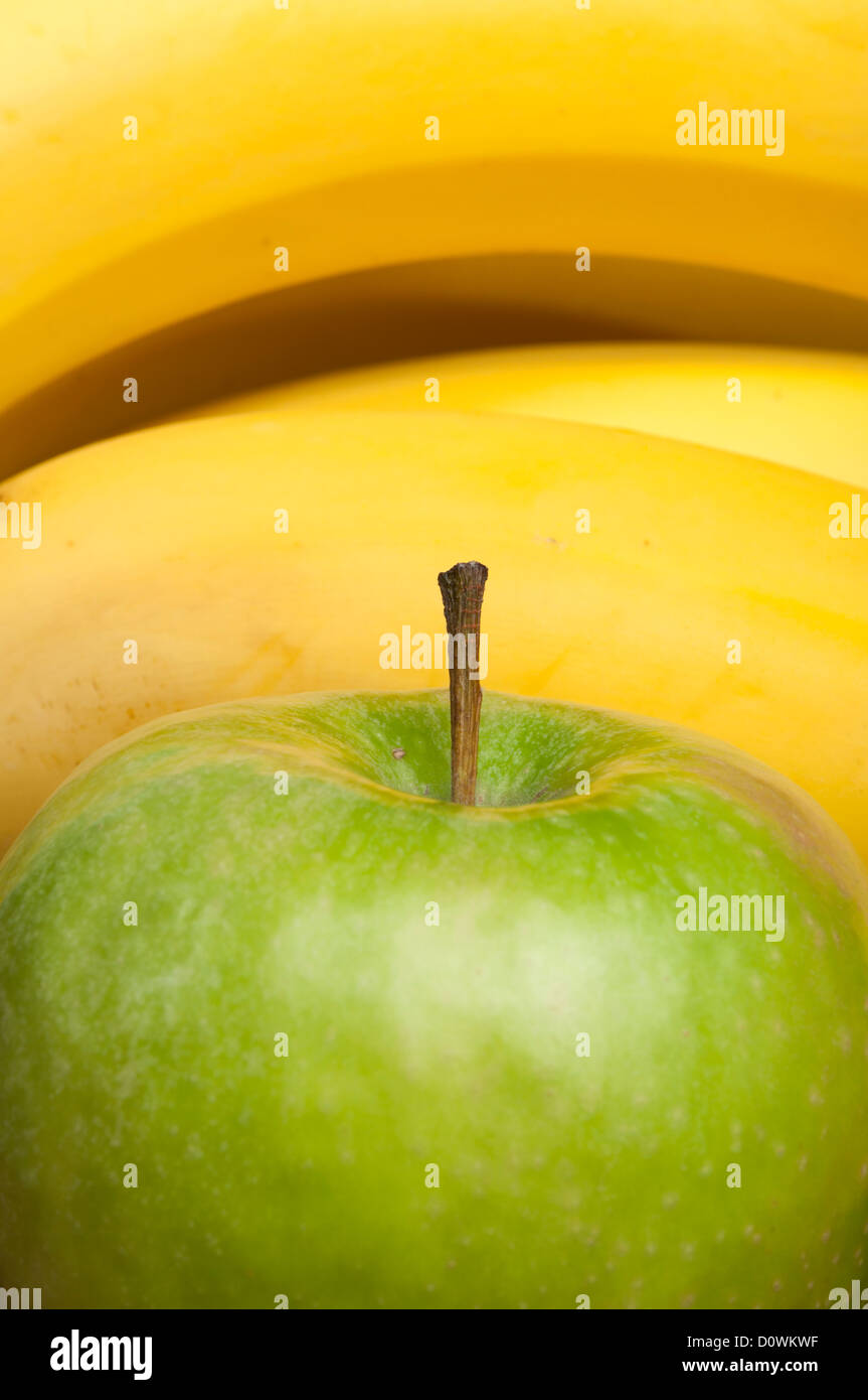 Green apple and bananas close up background Stock Photo - Alamy