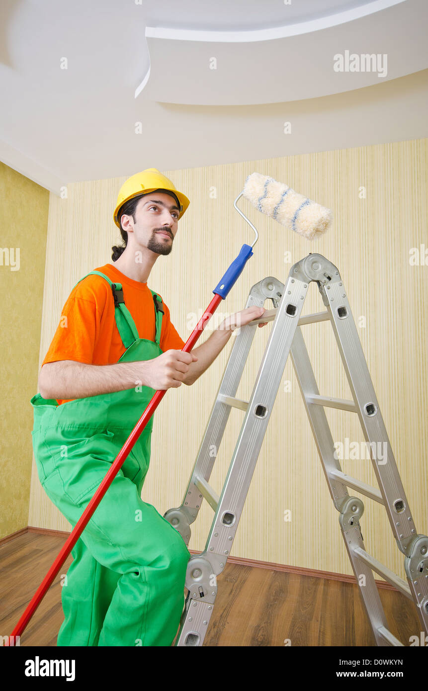 Painter worker during painting job Stock Photo - Alamy