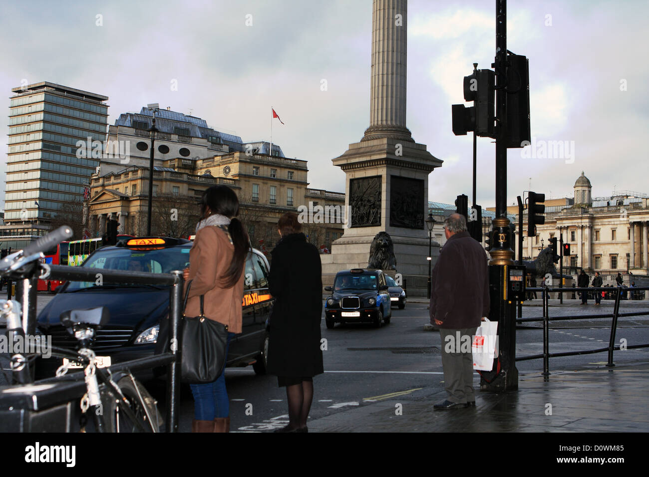 Traffic traveling along a road at Trafalgar Square in London while ...