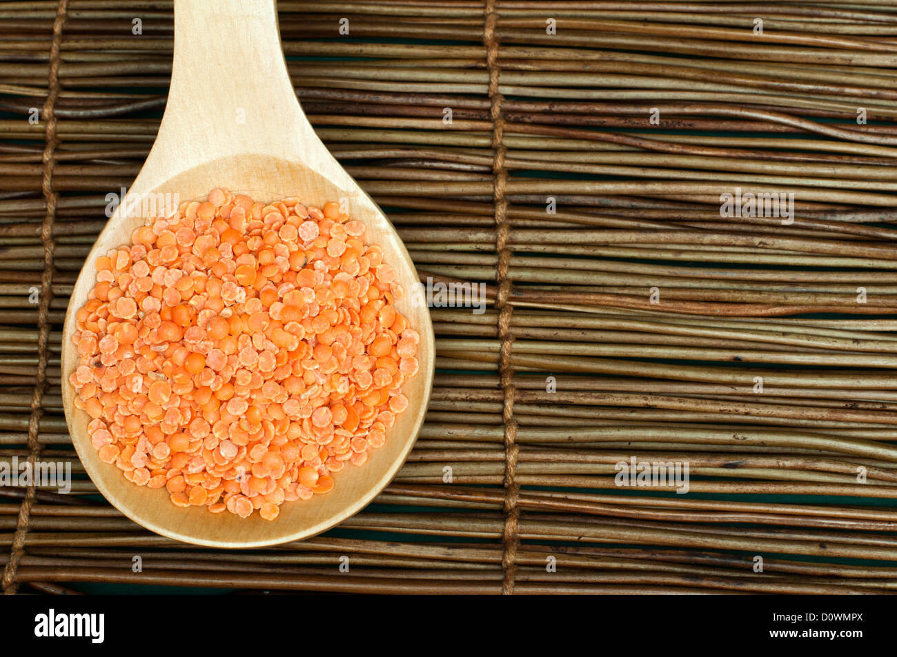 Lentil split in wooden spoon on wooden base. Copy spice Stock Photo - Alamy