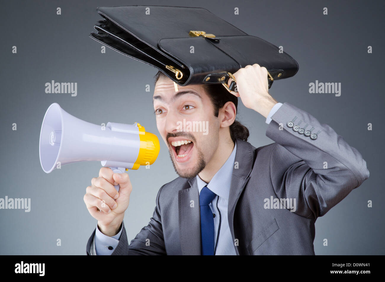 Businessman shouting via loudspeaker Stock Photo - Alamy