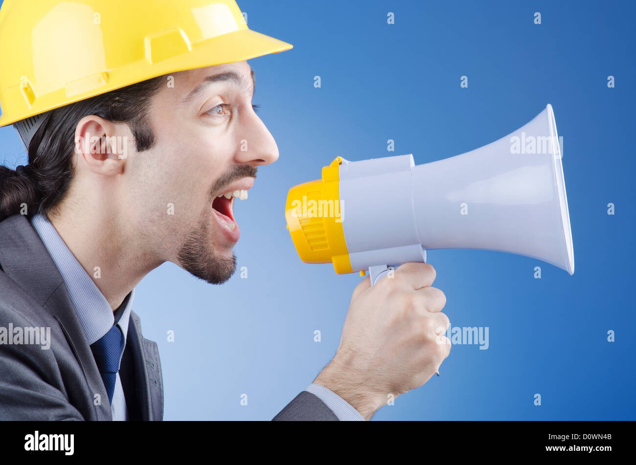 Construction worker shouting via loudspeaker Stock Photo - Alamy