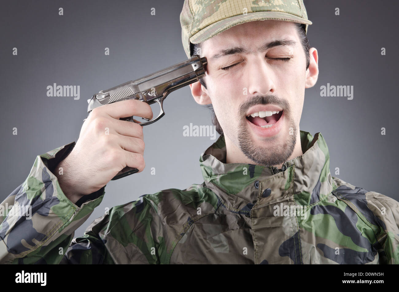 Soldier with gun in studio shooting Stock Photo - Alamy