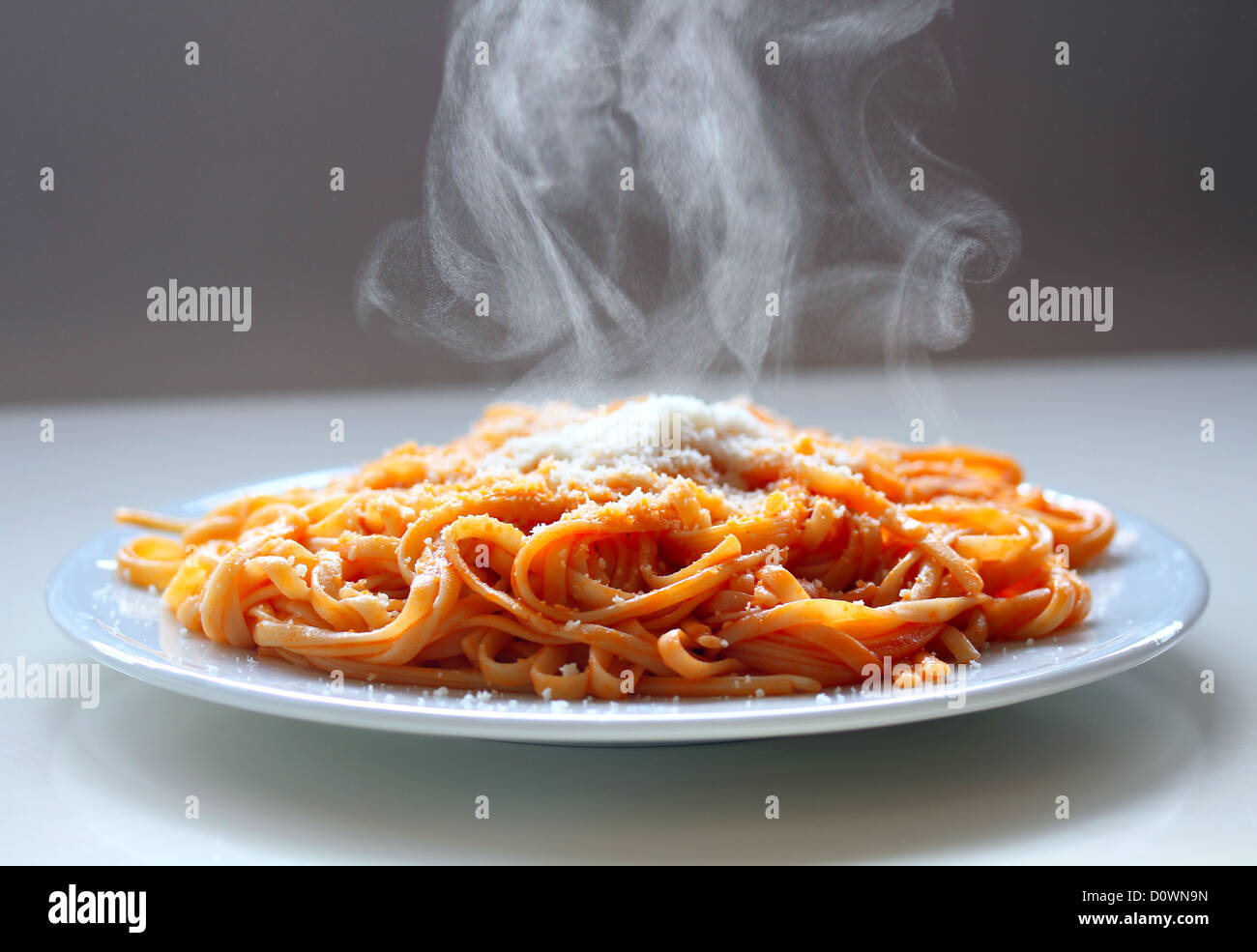 Italian spaghetti steaming with parmesan cheese Stock Photo - Alamy