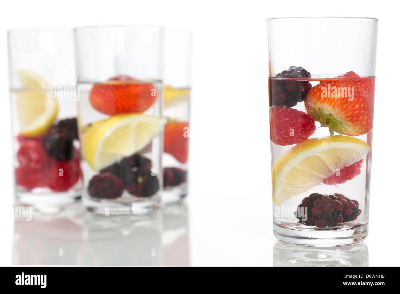 mixed fruit in a clear glass with reflection Stock Photo - Alamy