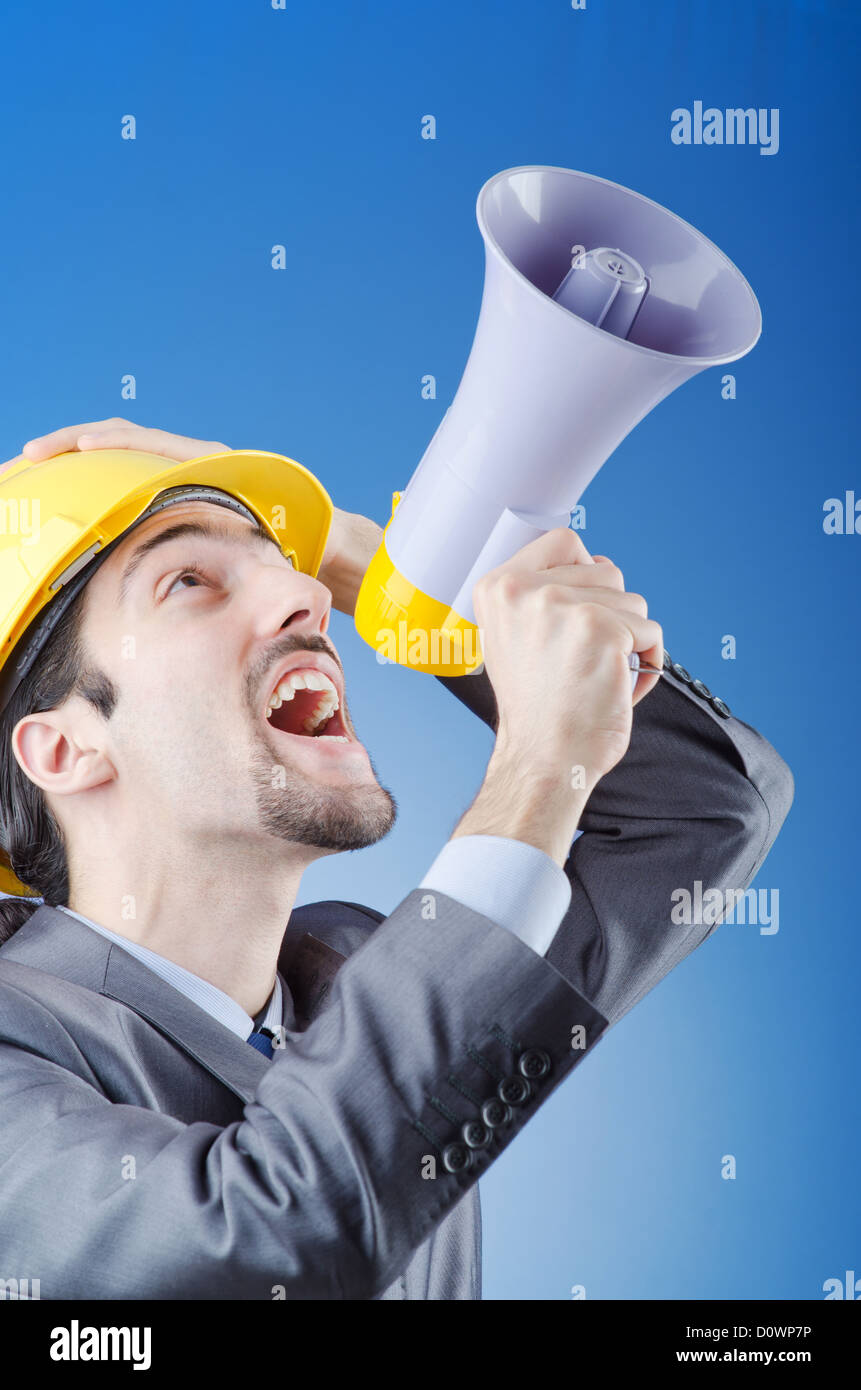 Construction worker shouting via loudspeaker Stock Photo - Alamy