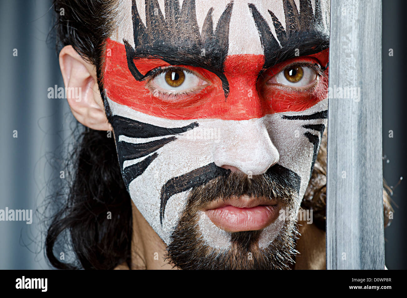 Man with face mask and sword Stock Photo - Alamy