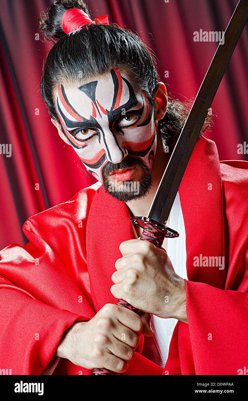 Man with face mask and sword Stock Photo - Alamy