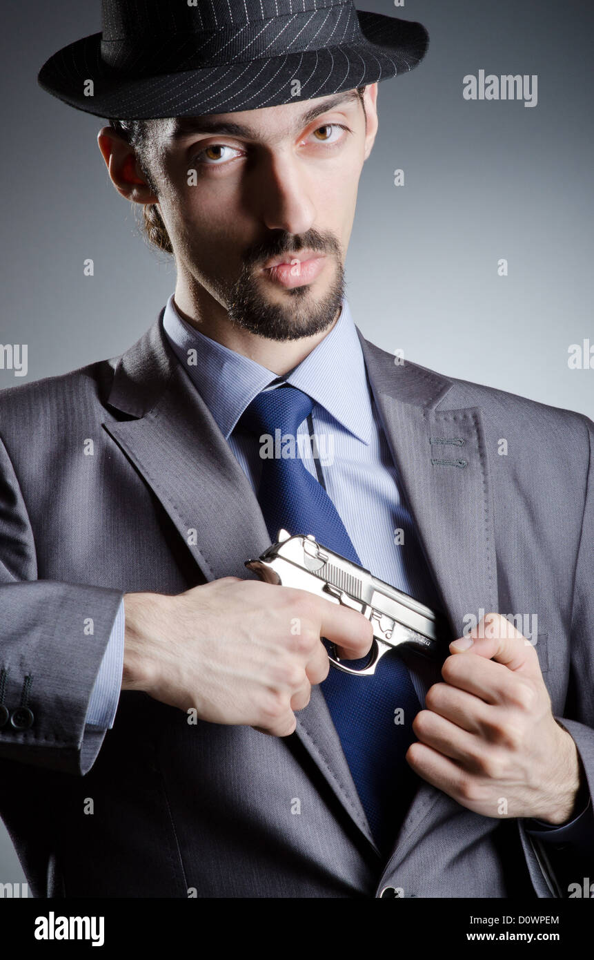 Businessman man with hand gun Stock Photo - Alamy