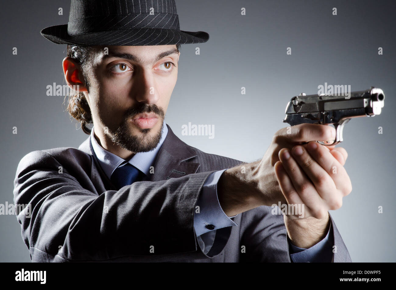 Businessman man with hand gun Stock Photo - Alamy