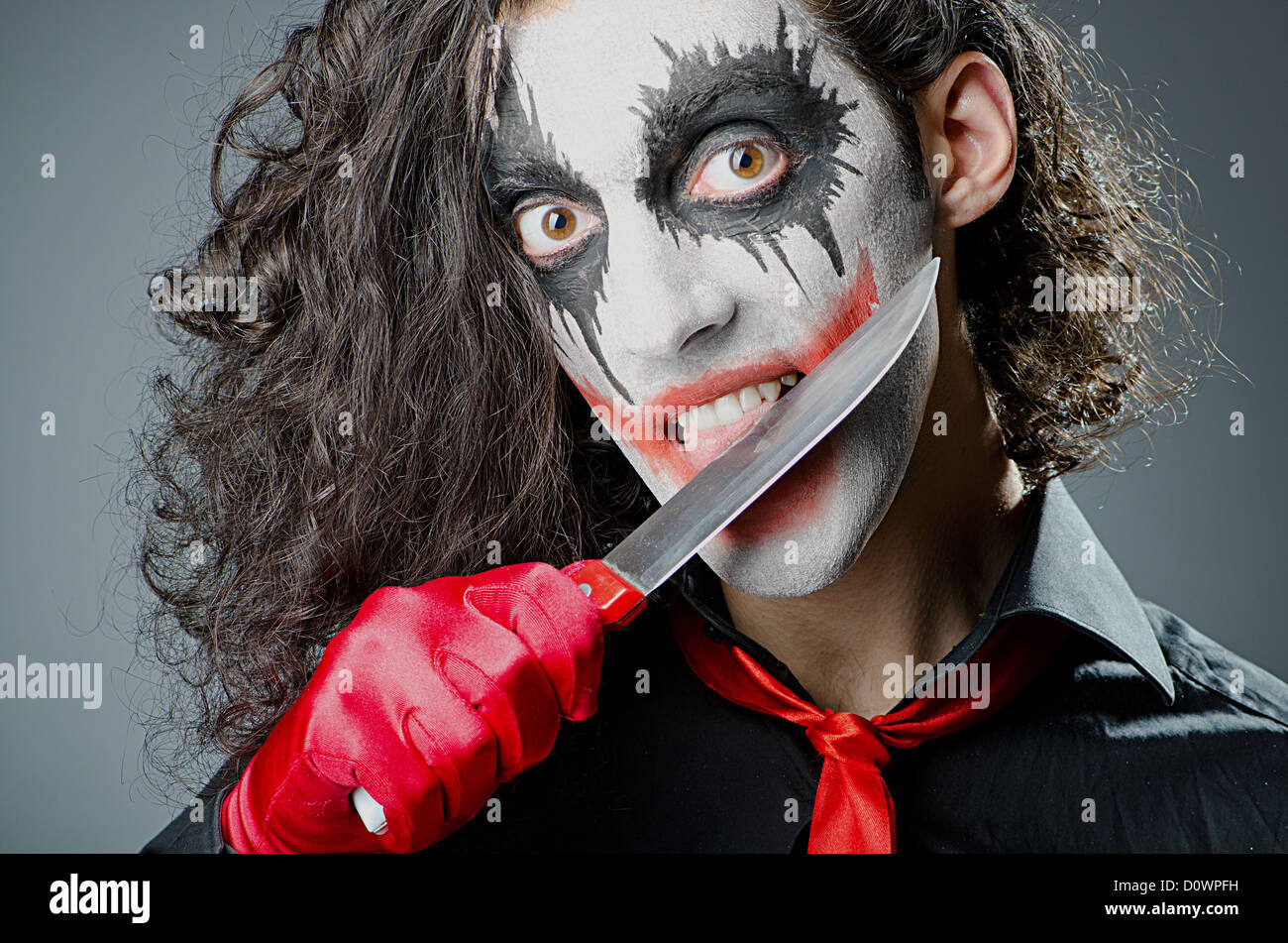 Joker with face mask in studio Stock Photo - Alamy