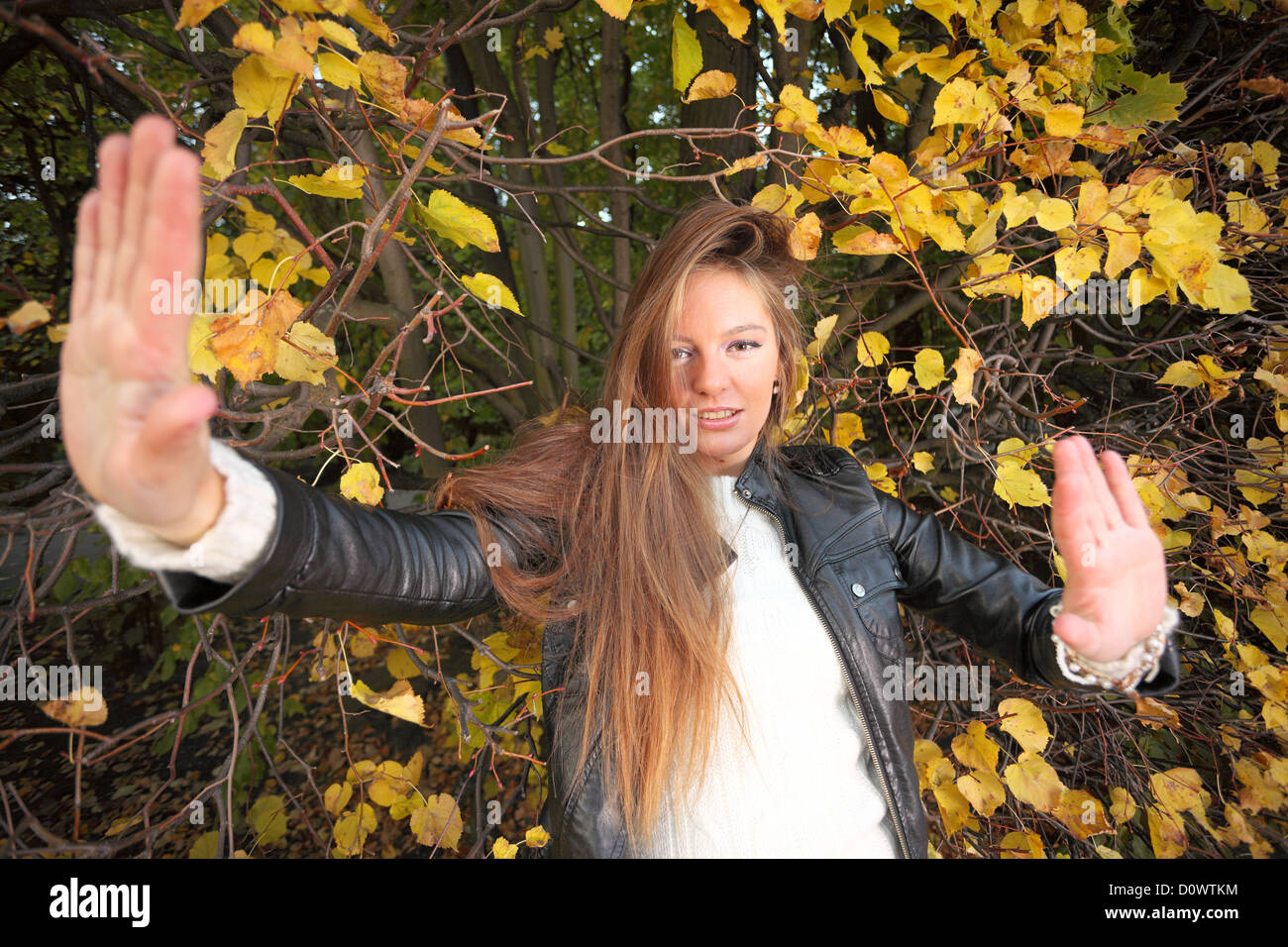 Young woman stand autumn leaves fall yellow green girl garden ...