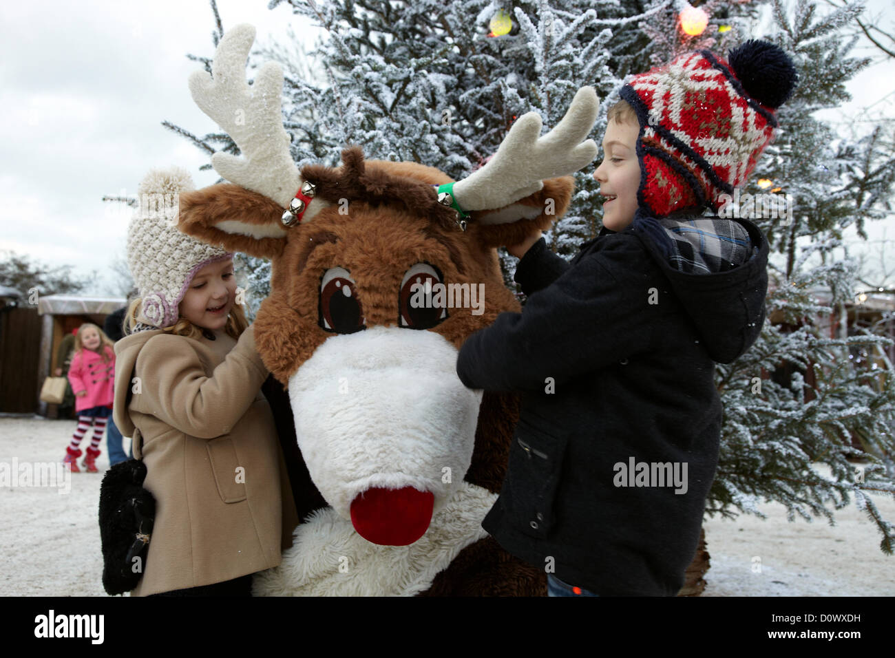 Children meet reindeer characters in the Elf village. Lapland UK, Bewl ...