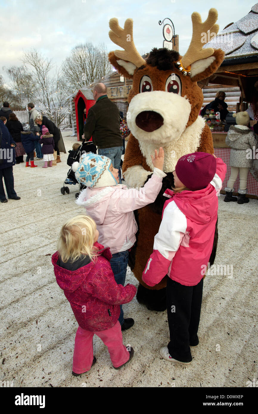 Children meet reindeer characters in the Elf village. Lapland UK, Bewl ...