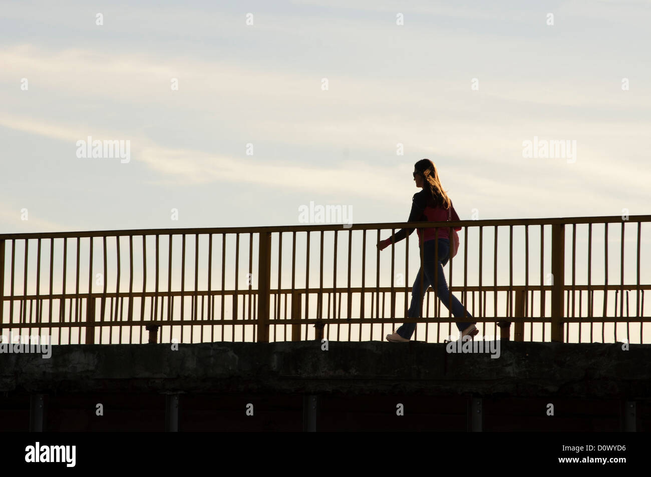 Girl crossing a bridge Stock Photo - Alamy