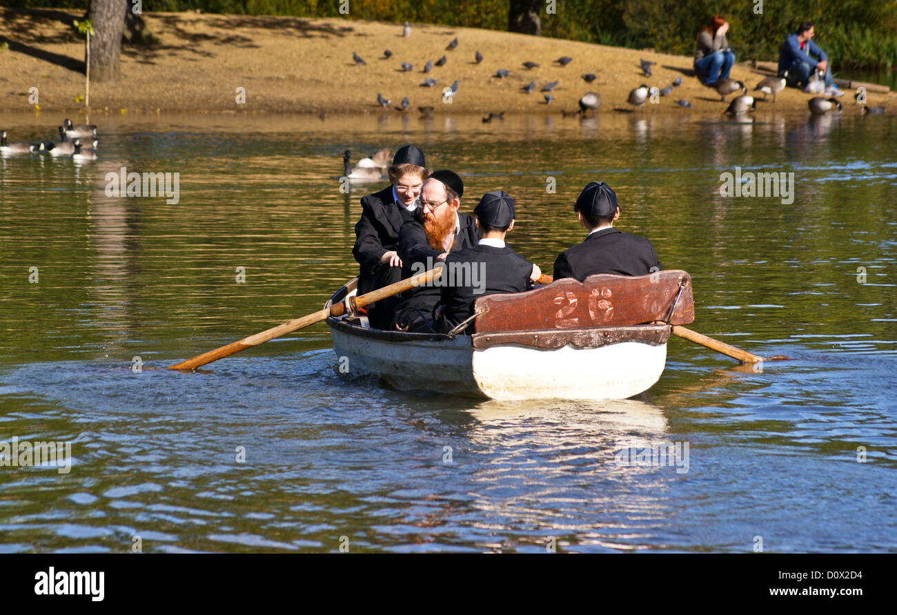 Four Orthodox Jewish men in a rowing boat, Hollow Ponds, Leytonstone ...