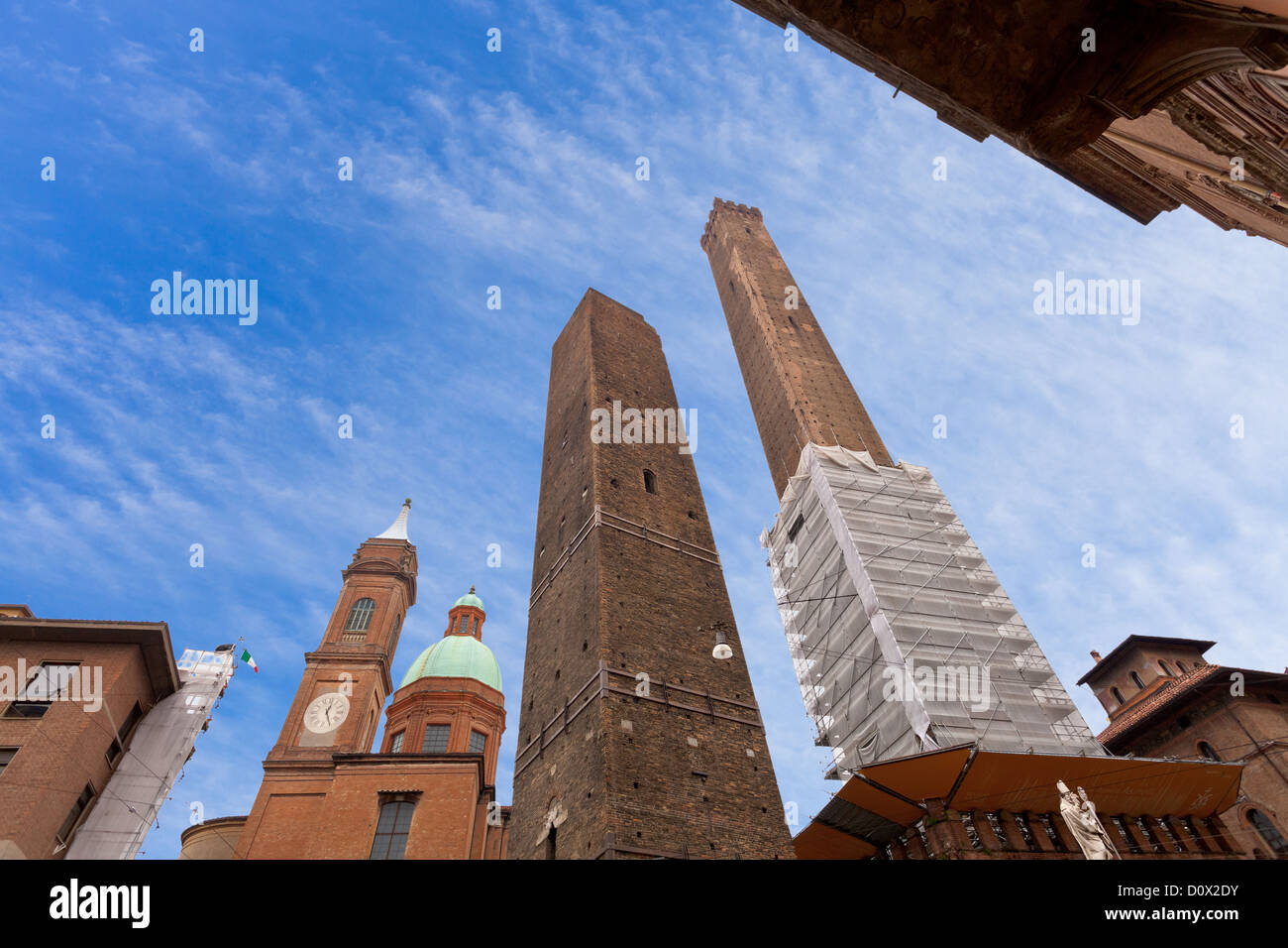 palace and two towers and statue of Saint Petronius under blue sky in ...