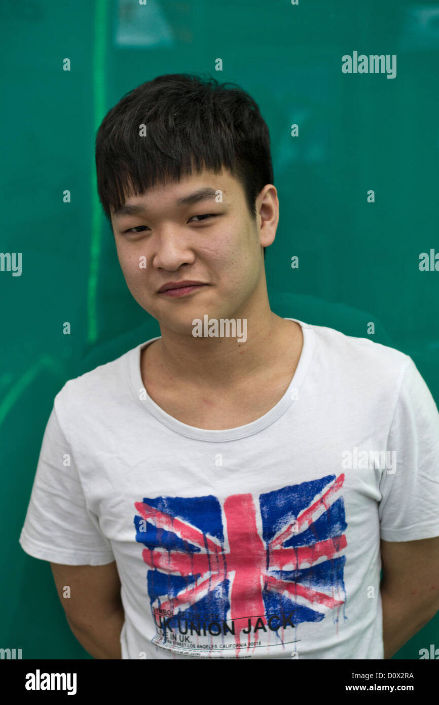 A young Chinese male wearing a white t-shirt with a British Union Jack ...