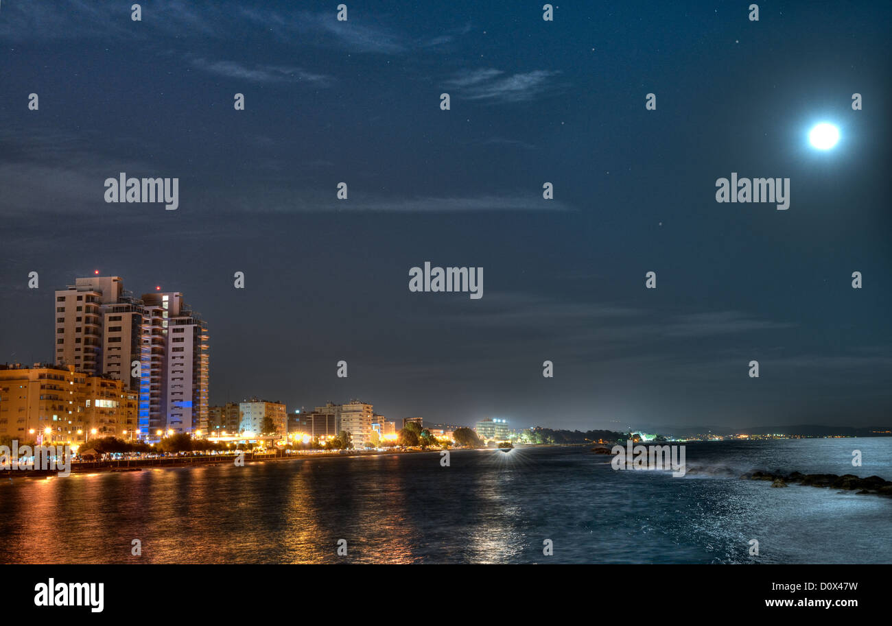 Limassol seafront during the night with full moon showing the sea and ...