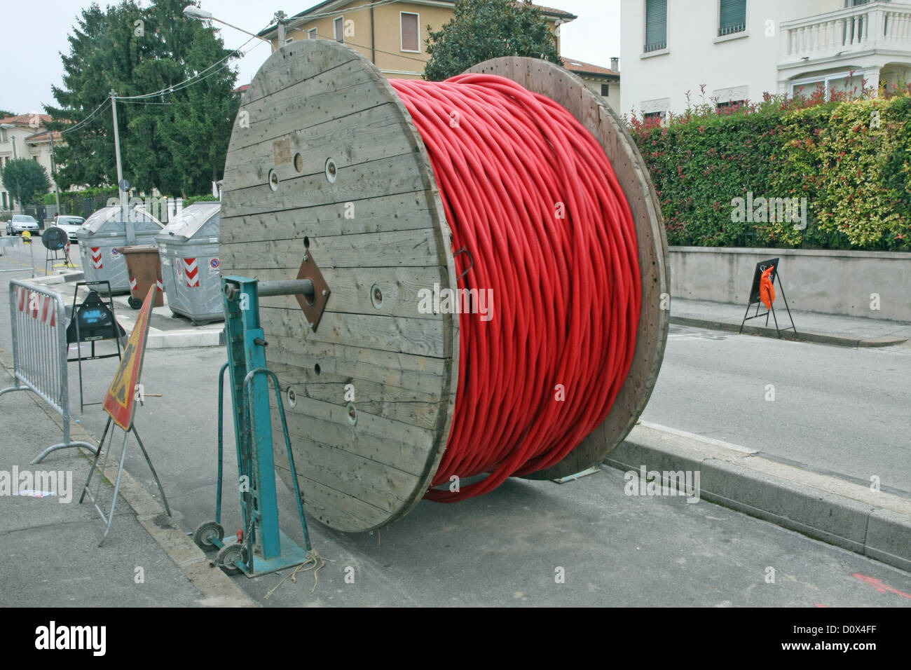 huge coils of red high-voltage power cable in the middle of the road ...