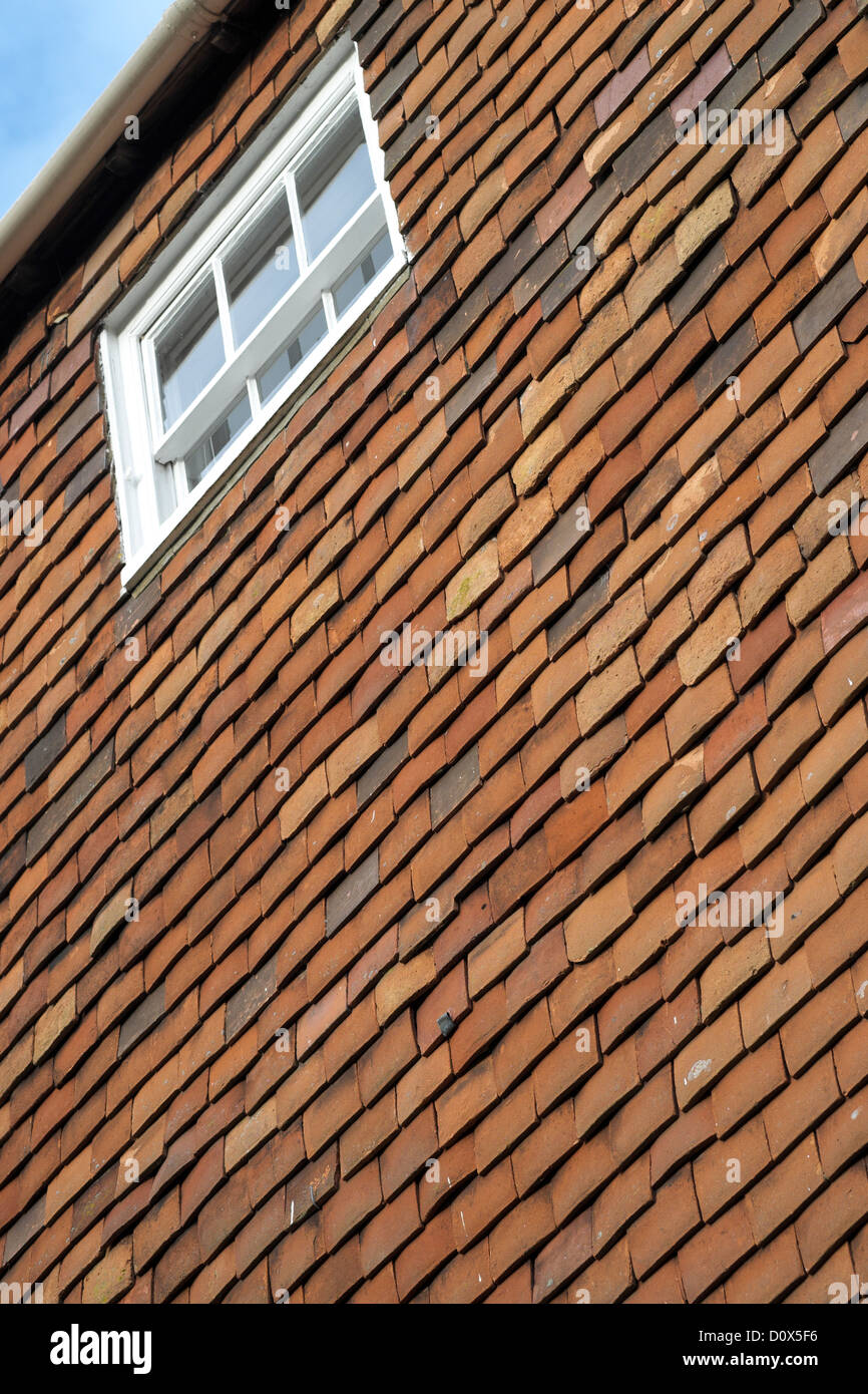 Clay tile hung wall and small window Stock Photo - Alamy