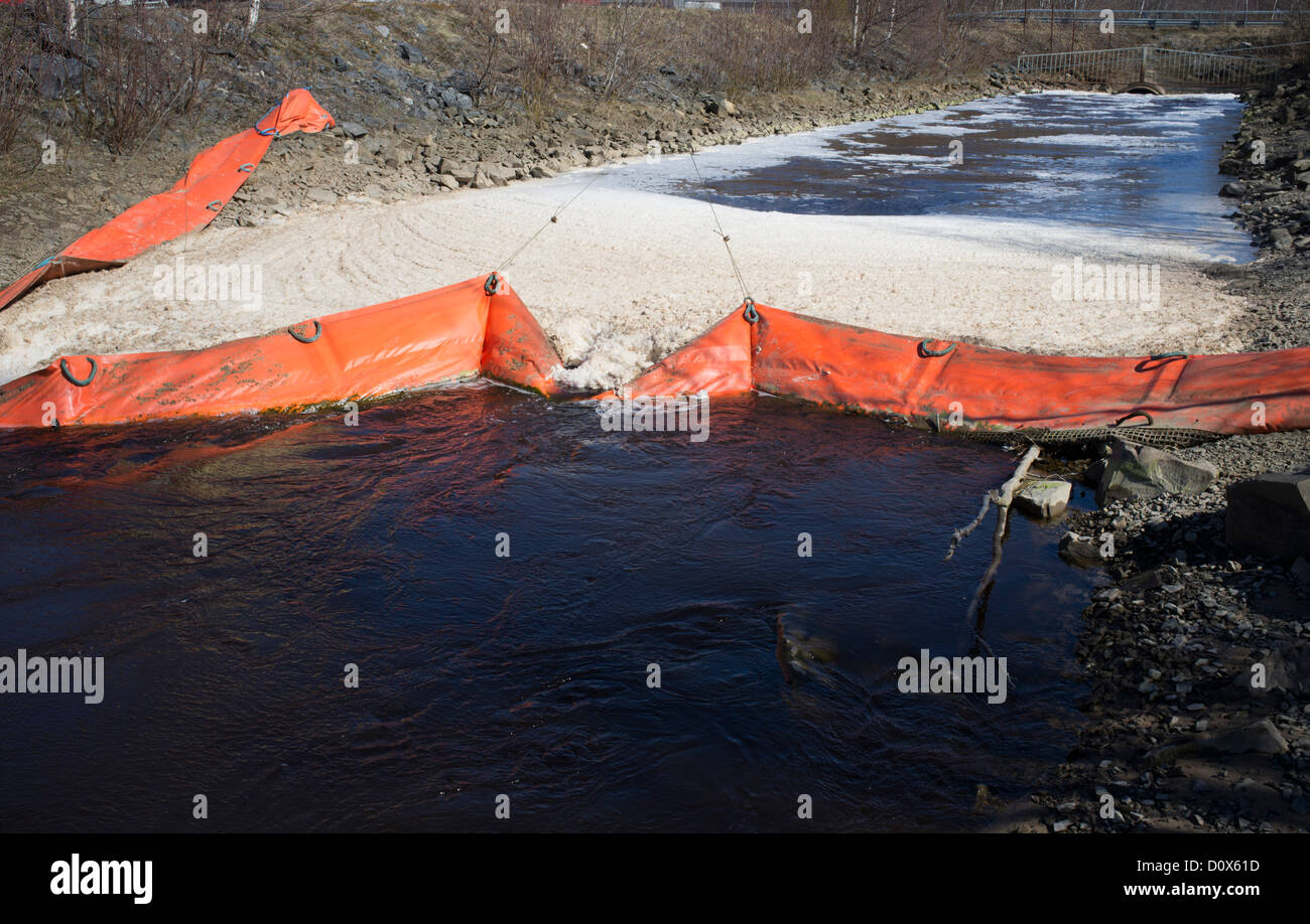 Surface containment boom prevents wastewater entering a river at river ...