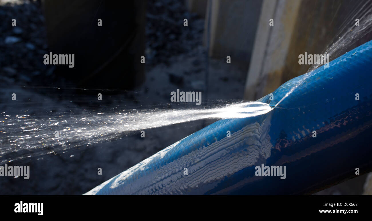 Leaking water hose Stock Photo - Alamy