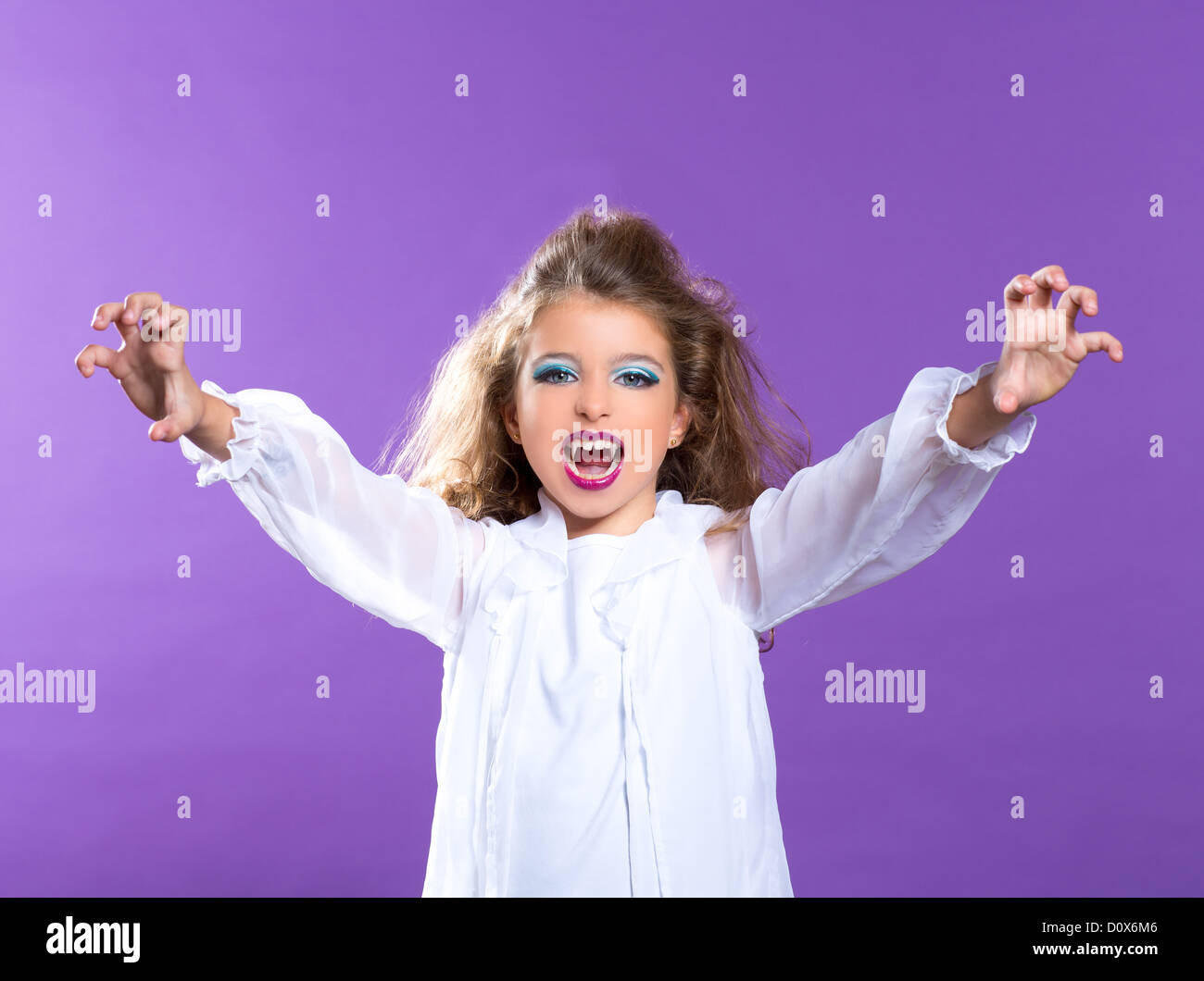 Children vampire makeup kid girl on purple background Stock Photo - Alamy