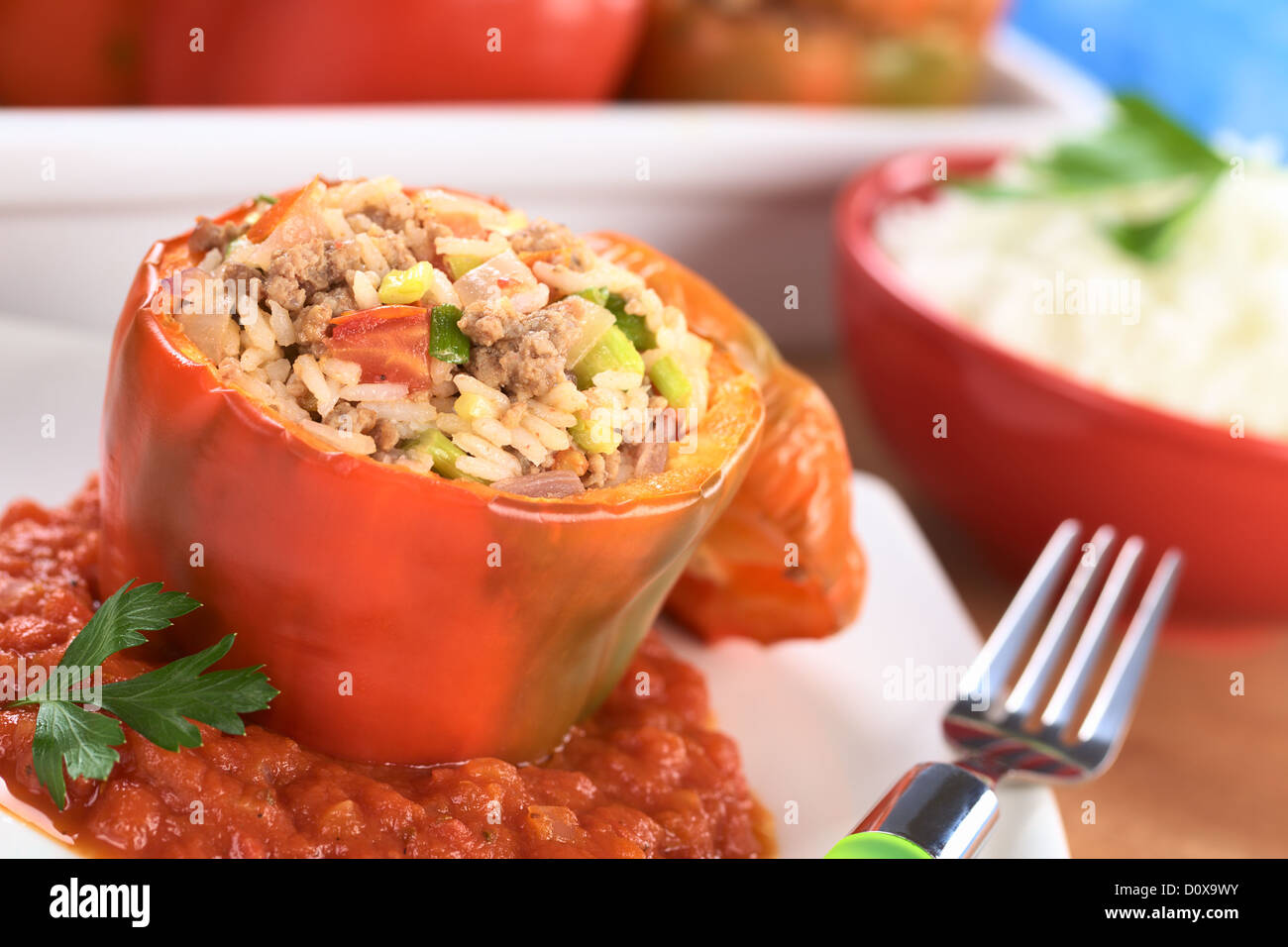 Baked stuffed red bell pepper filled with minced meat, onion, rice ...