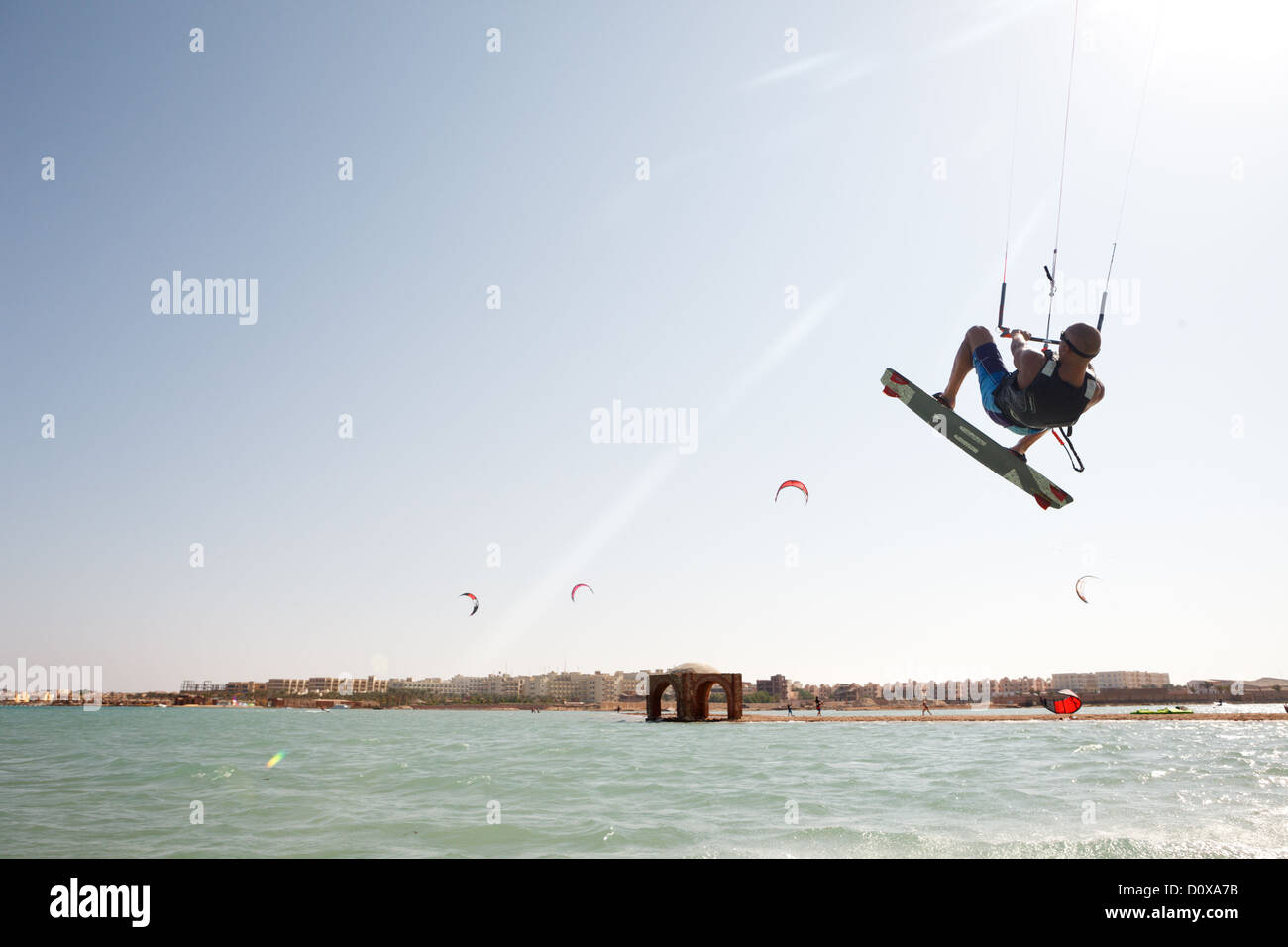 Kiteboarder enjoy surfing in blue water and jumps high in the air Stock ...