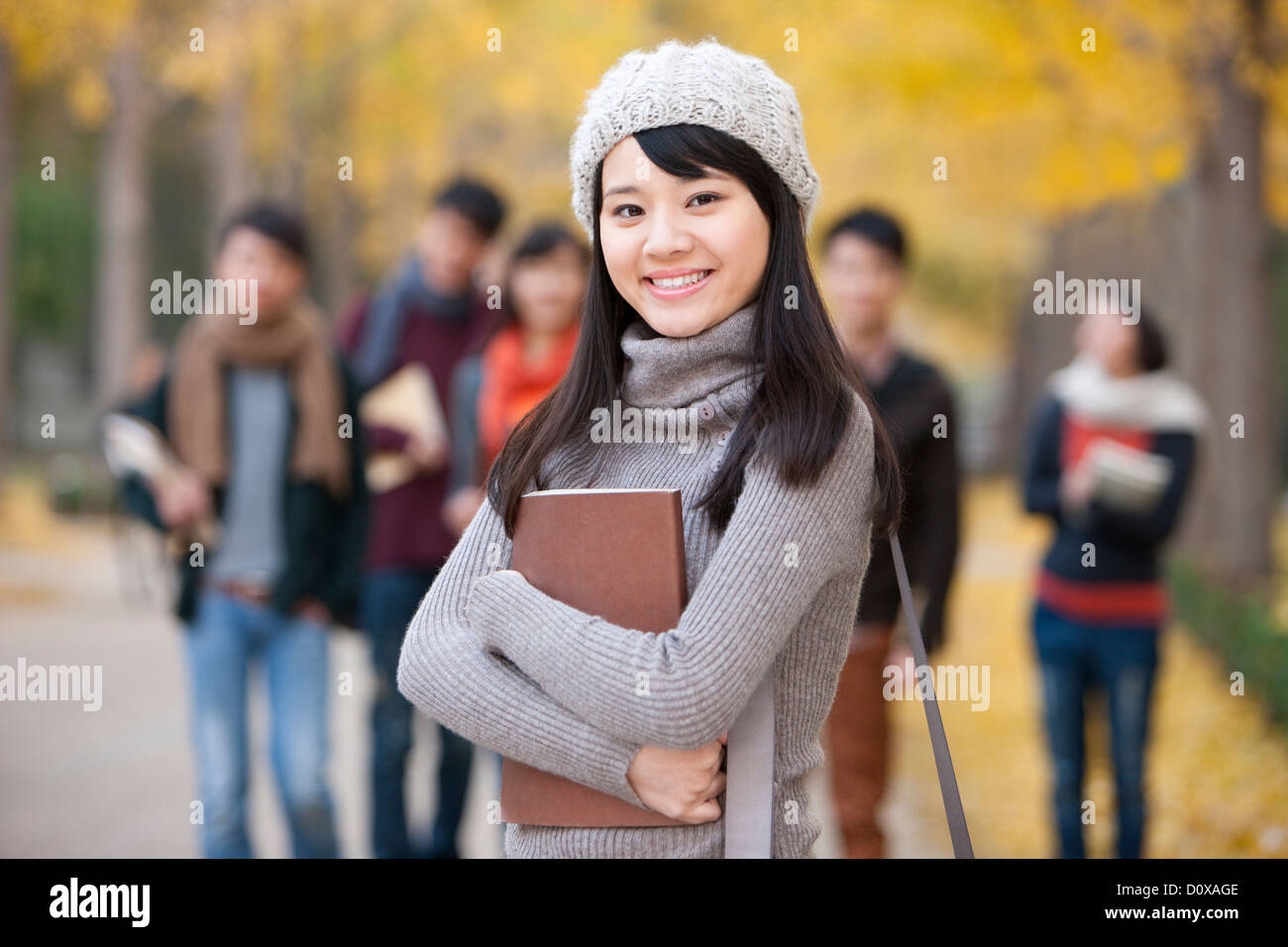 Female college student on campus with her friends in background Stock ...