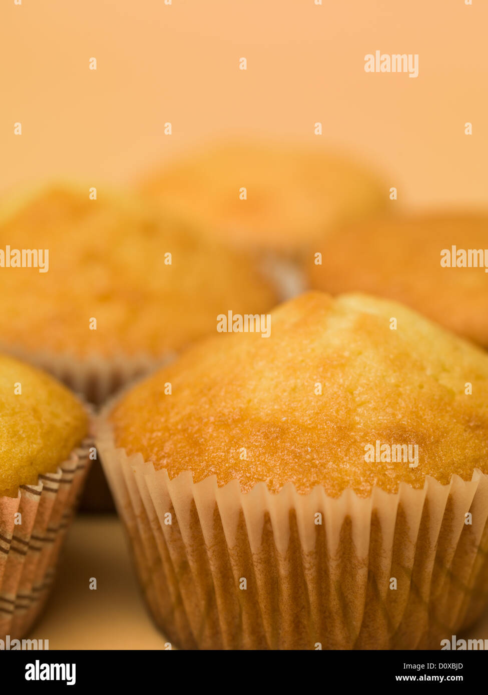 simple gold muffins beige background detail Stock Photo - Alamy