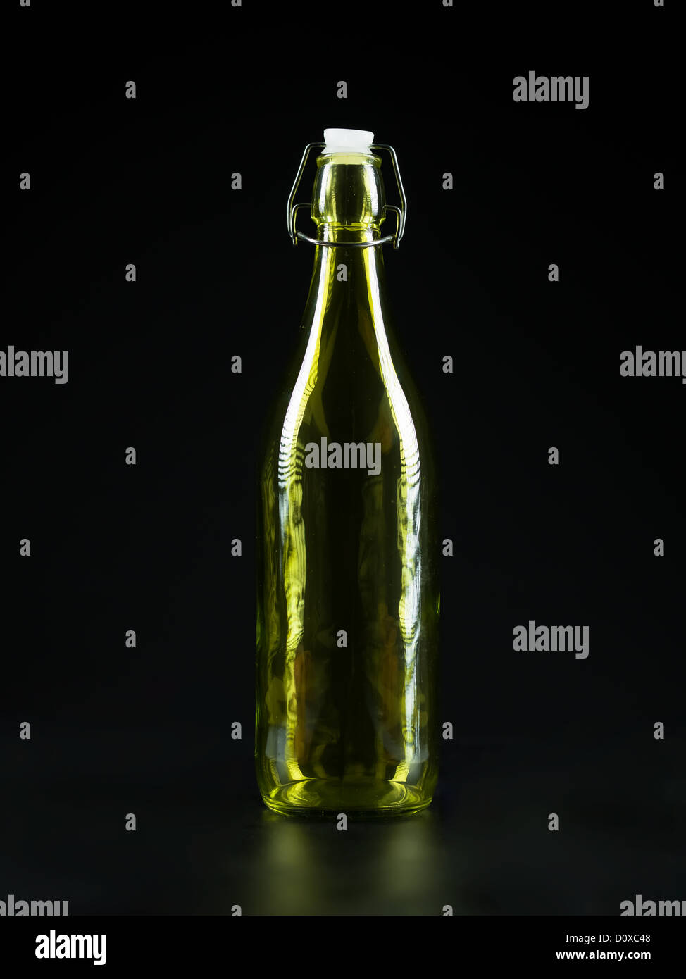 green transparent bottle on black background Stock Photo - Alamy