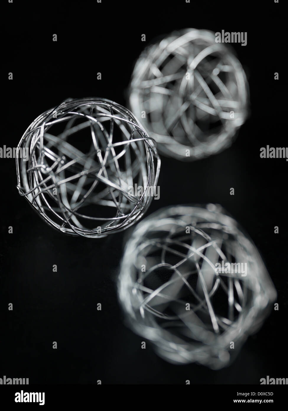 three wire recycled ball on black background Stock Photo - Alamy