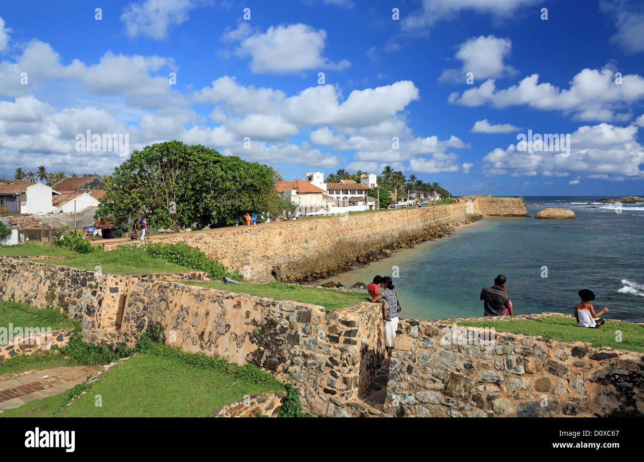 People enjoying the ocean view from the outside walls of historic Galle ...