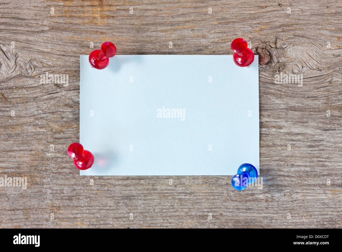 Blue sheet of paper for note and pushpins on the board Stock Photo - Alamy