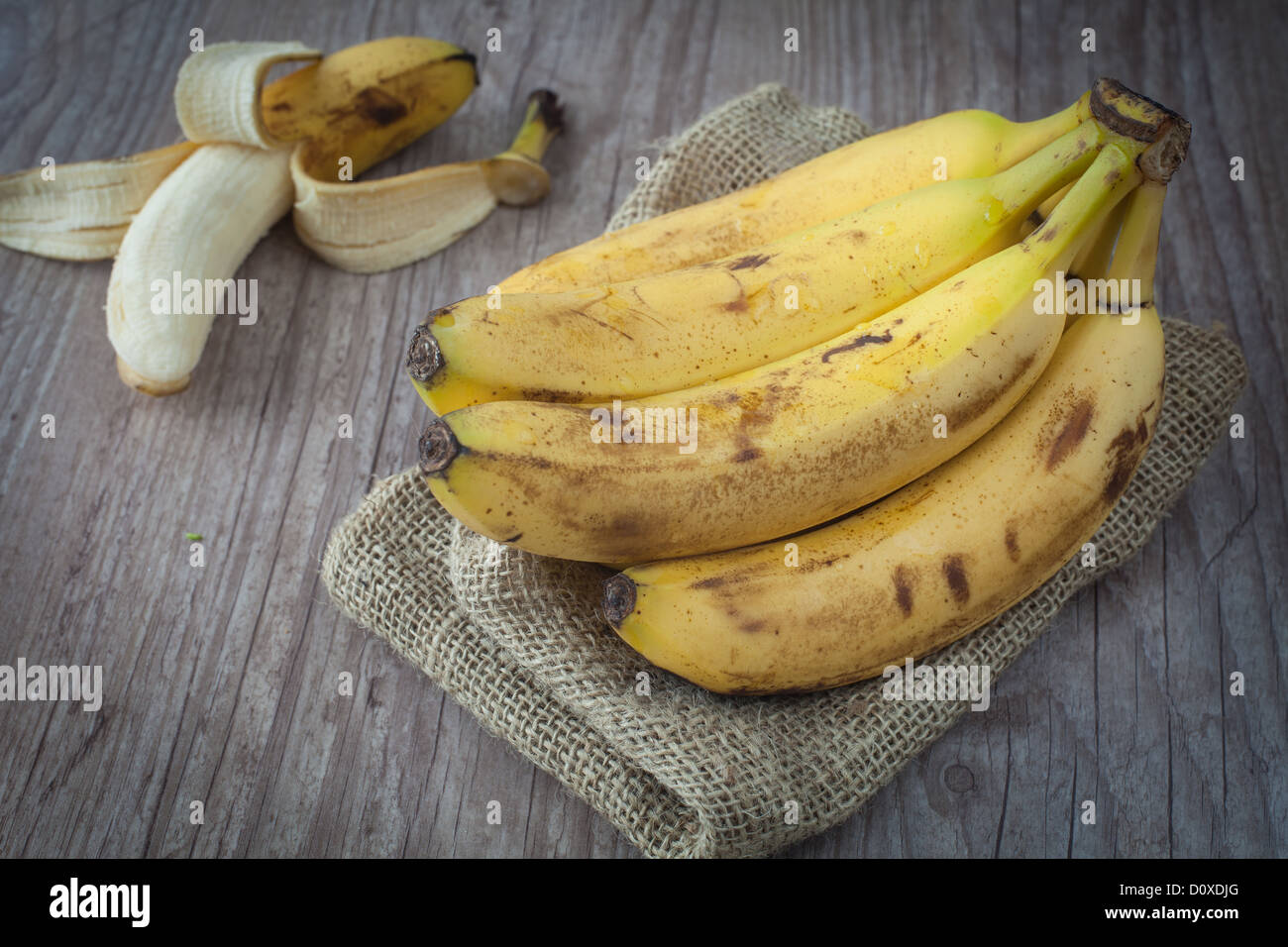 Bunch of fresh banana fruit on a wooden background Stock Photo - Alamy